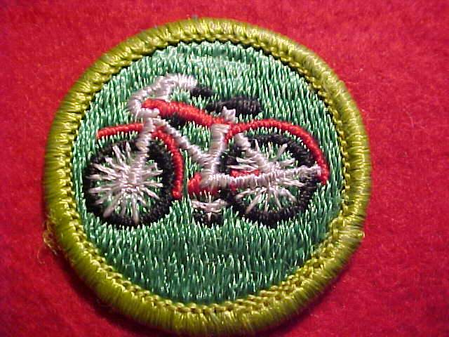 CYCLING, MERIT BADGE WITH CLEAR PLASTIC BACK, GREEN BORDER, NO IMPRINT ...